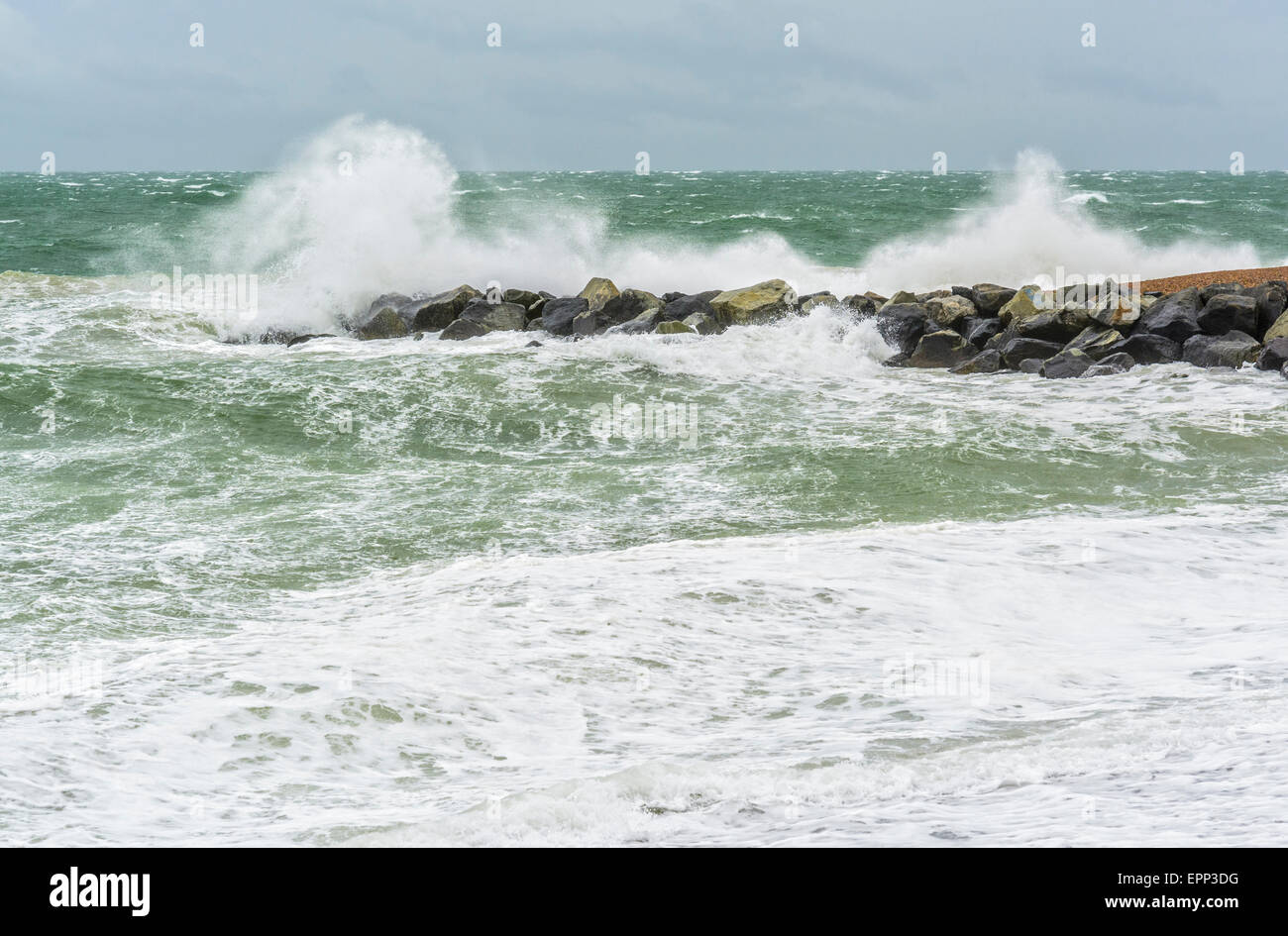 Rough sea with waves splashing on rocks Stock Photo - Alamy