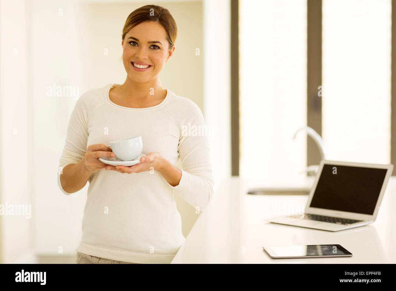 happy woman drinking tea in the kitchen at home Stock Photo - Alamy