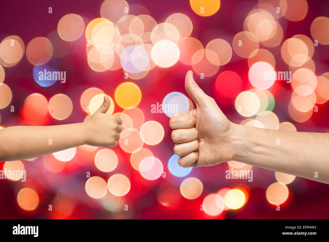 father and son hands giving like on christmas lights background Stock ...