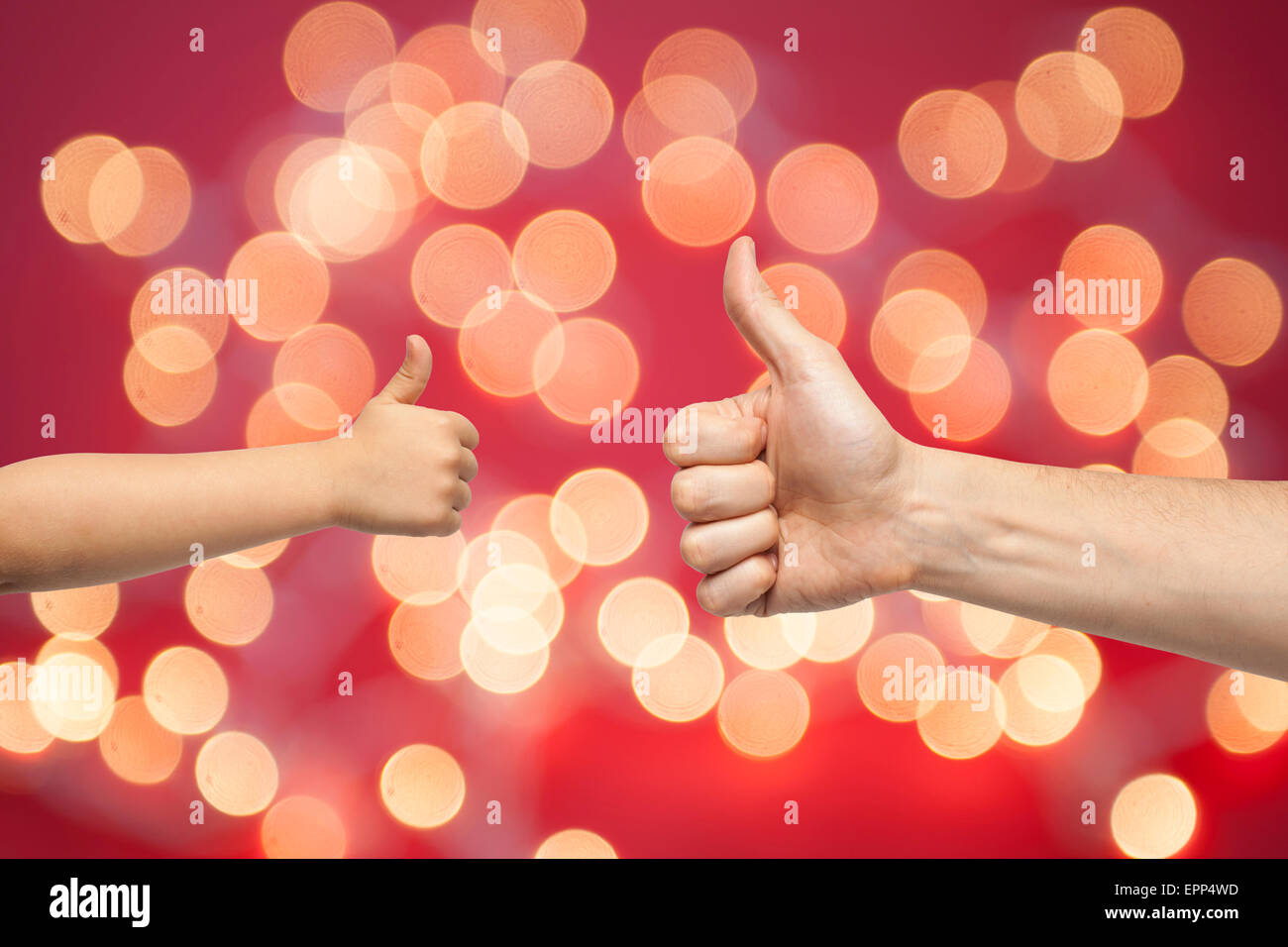father and son hands giving like on christmas lights background Stock ...