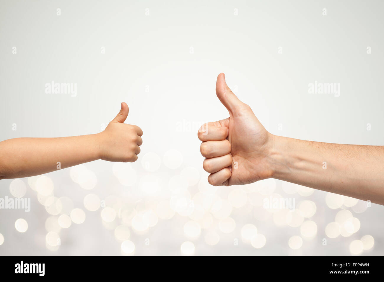 father and son hands giving like on christmas lights background Stock ...