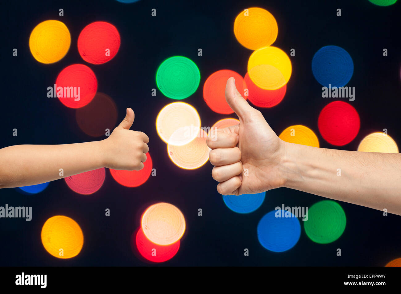 father and son hands giving like on christmas lights background Stock ...