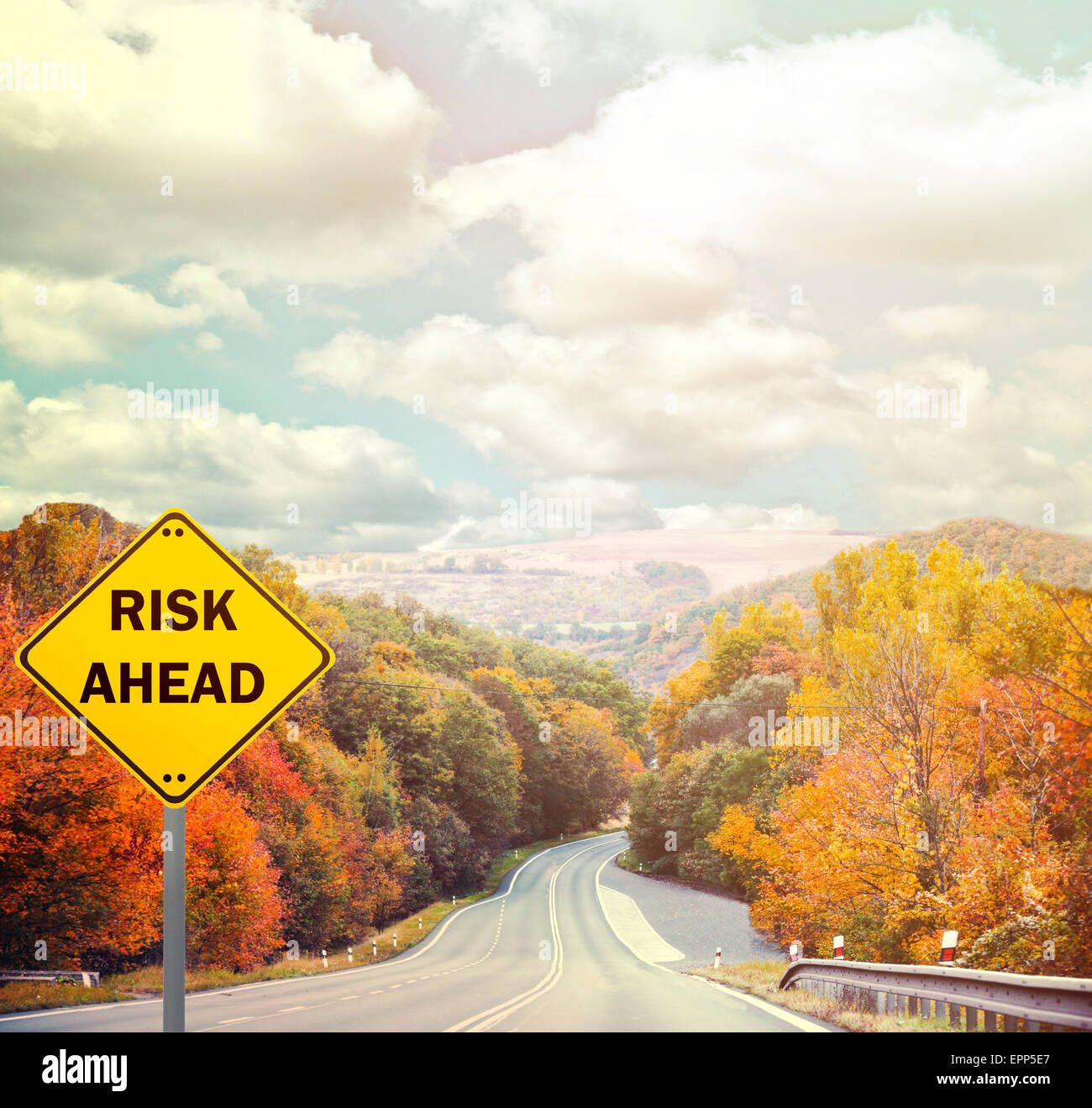 RISK AHEAD sign against road - Business concept Stock Photo - Alamy