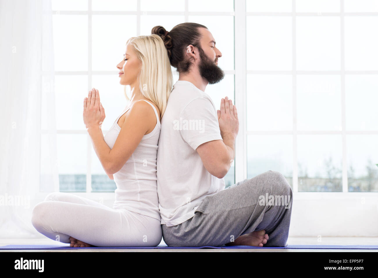 Yoga concept with young woman and man Stock Photo - Alamy