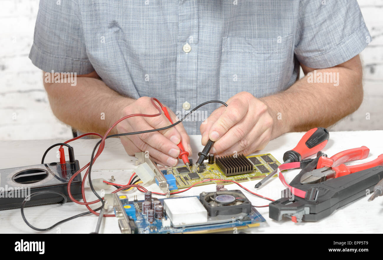 a technician repairing a computer with different tools Stock Photo - Alamy
