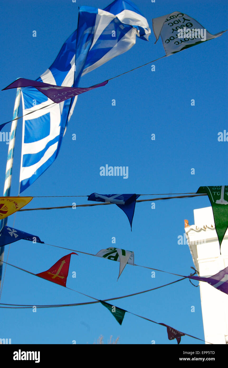 Flags flying against a blue sky on Mykonos Greece Stock Photo - Alamy