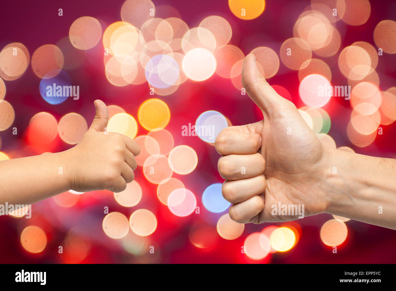 father and son hands giving like on christmas lights background Stock ...