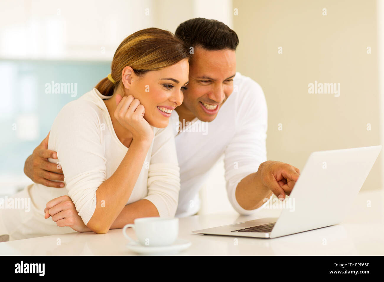 happy couple using laptop computer in the kitchen Stock Photo - Alamy