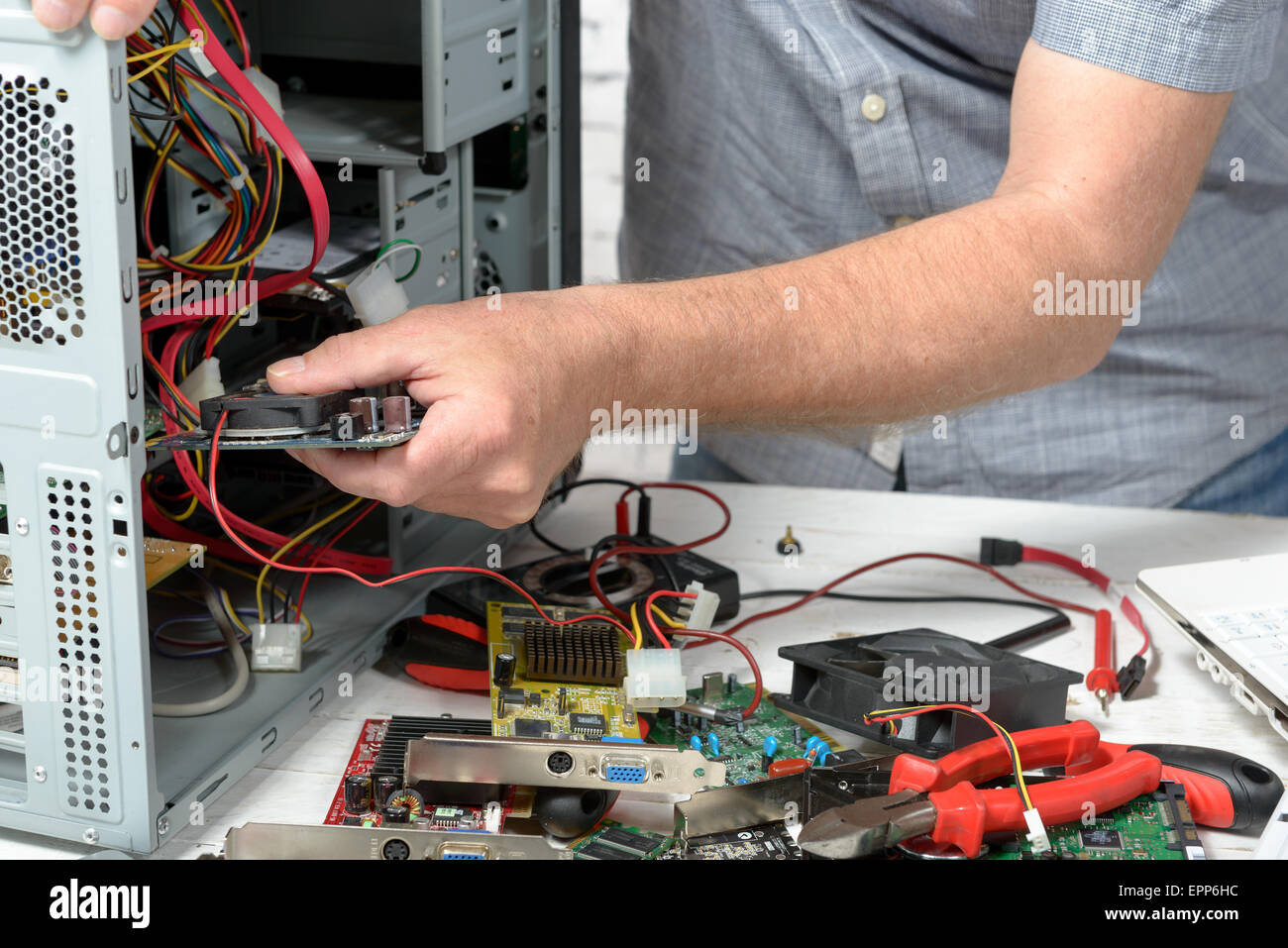 a technician repairing a computer with different tools Stock Photo - Alamy