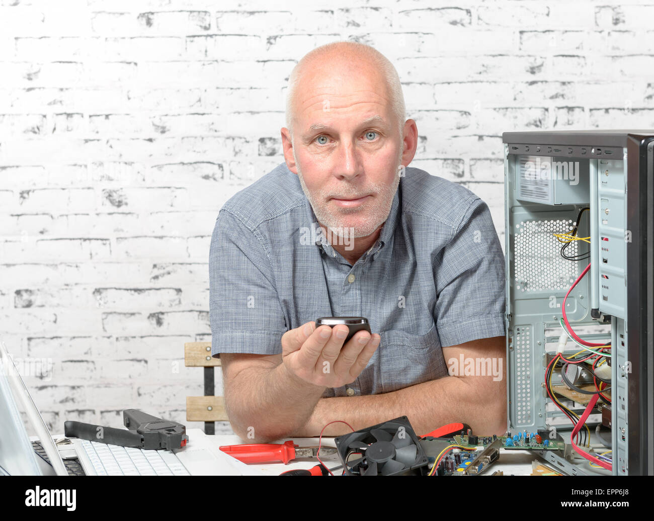 a technician repairing a computer with different tools Stock Photo - Alamy