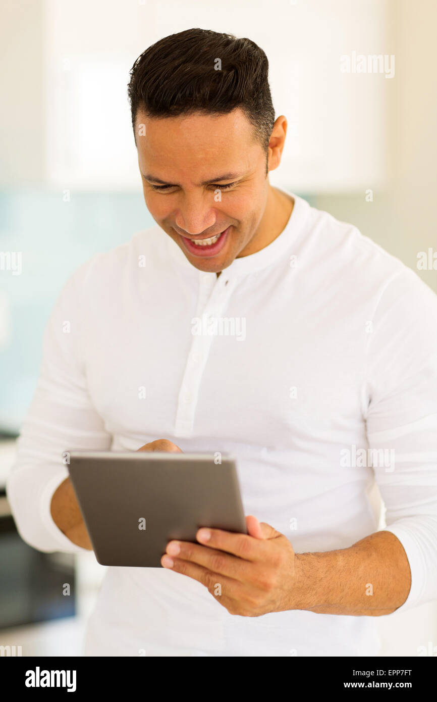 happy mid age man using tablet computer Stock Photo - Alamy