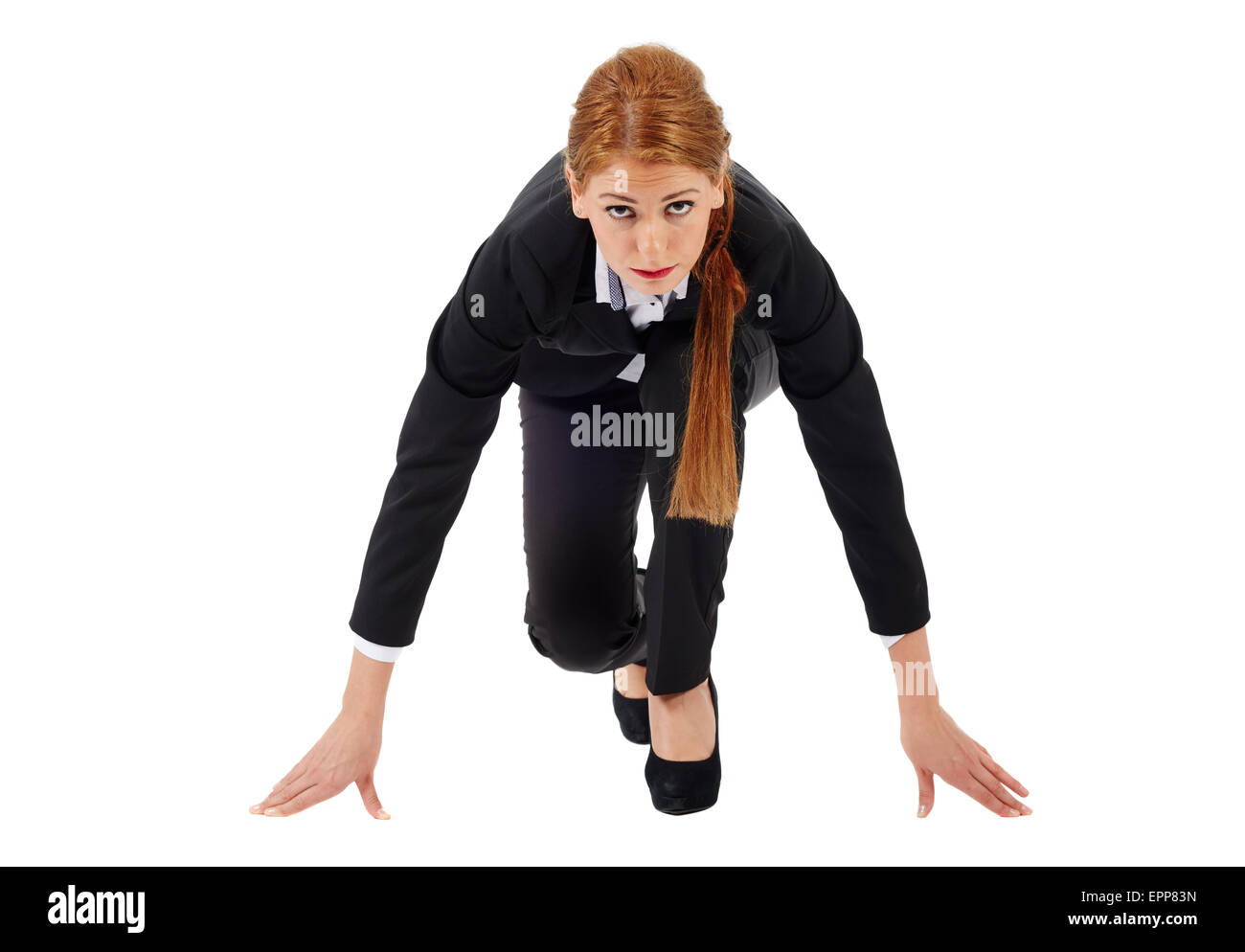 Young businesswoman taking position for start in a race, isolated on ...