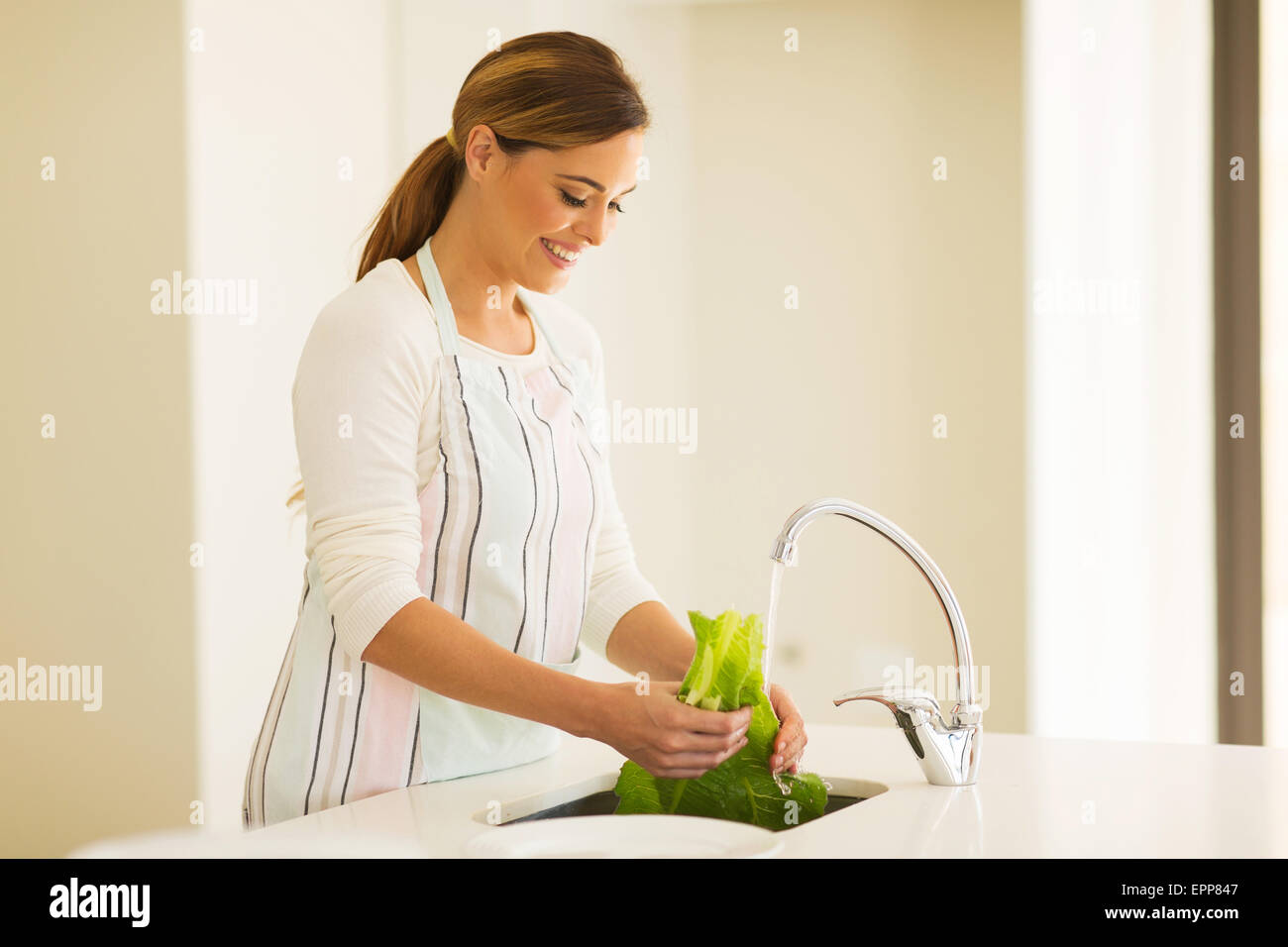 Woman washing utensils hi-res stock photography and images - Alamy