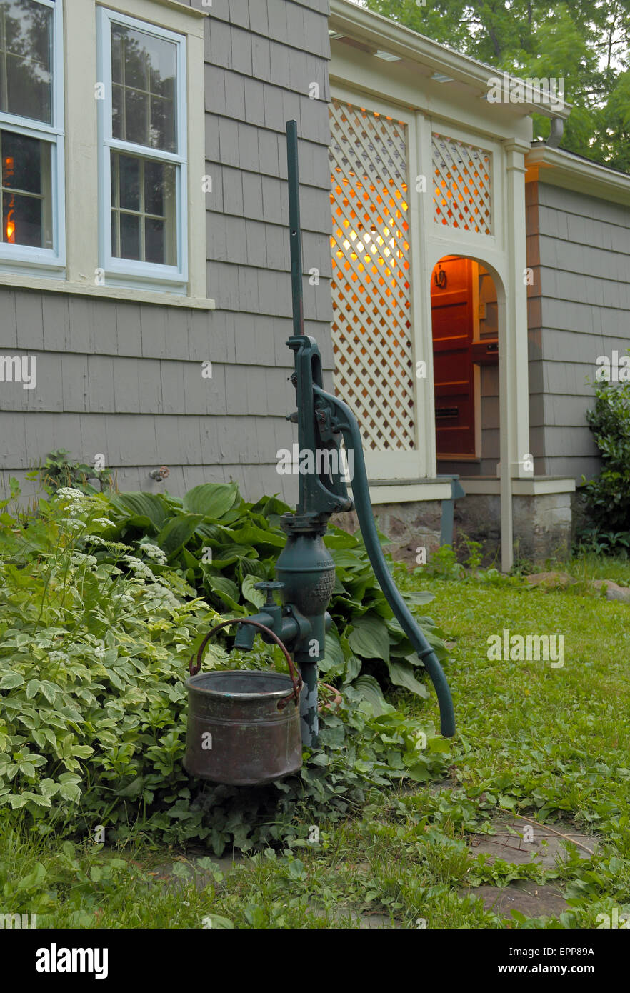 An outdoor water pump by the side of a nice home Stock Photo - Alamy