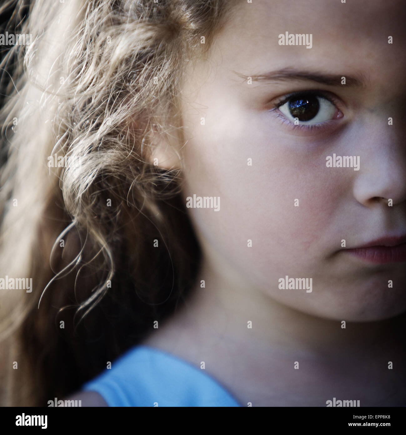 Cropped front view portrait of a young girl staring at the camera Stock ...