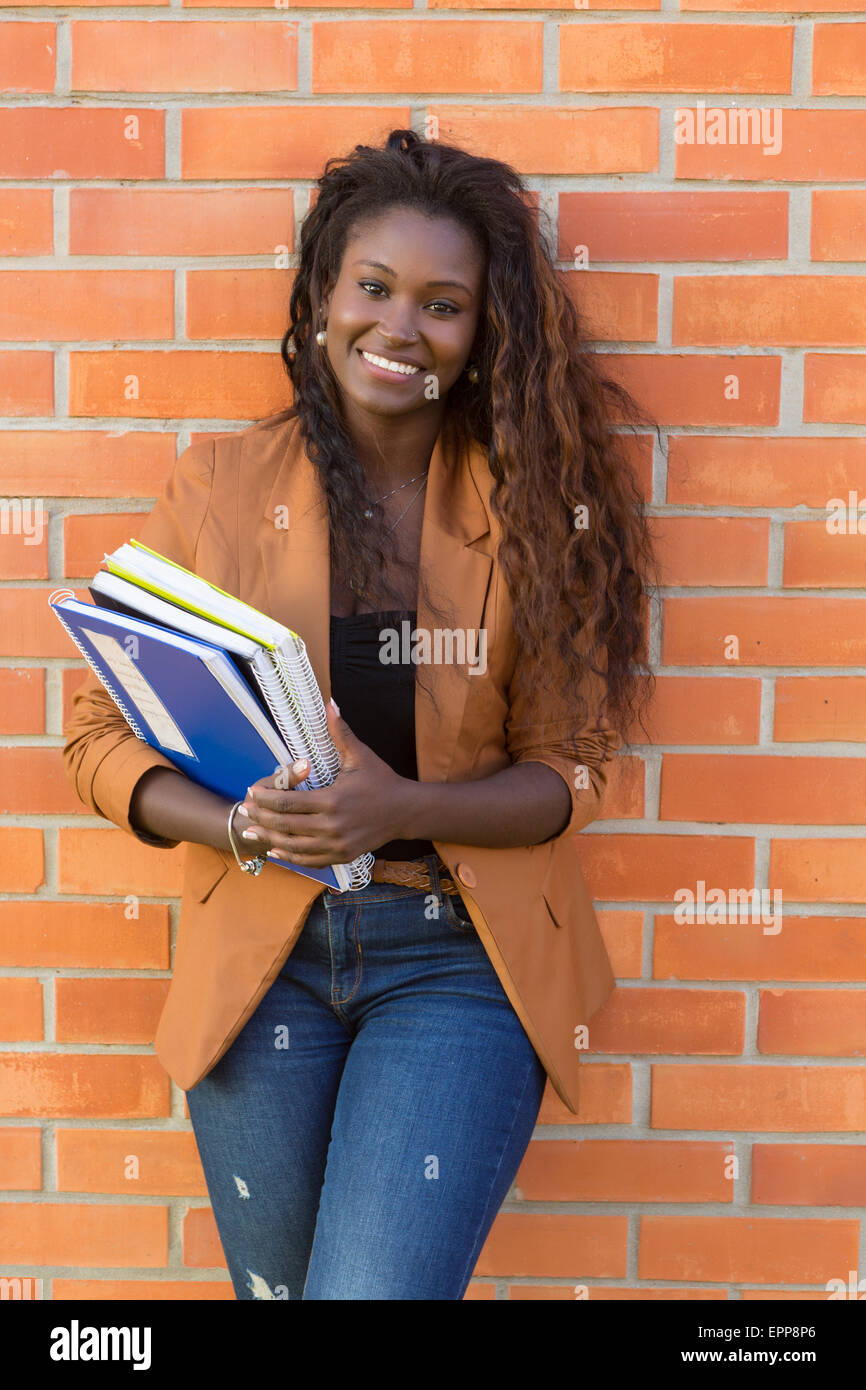Happy student relaxing at the university campus Stock Photo - Alamy