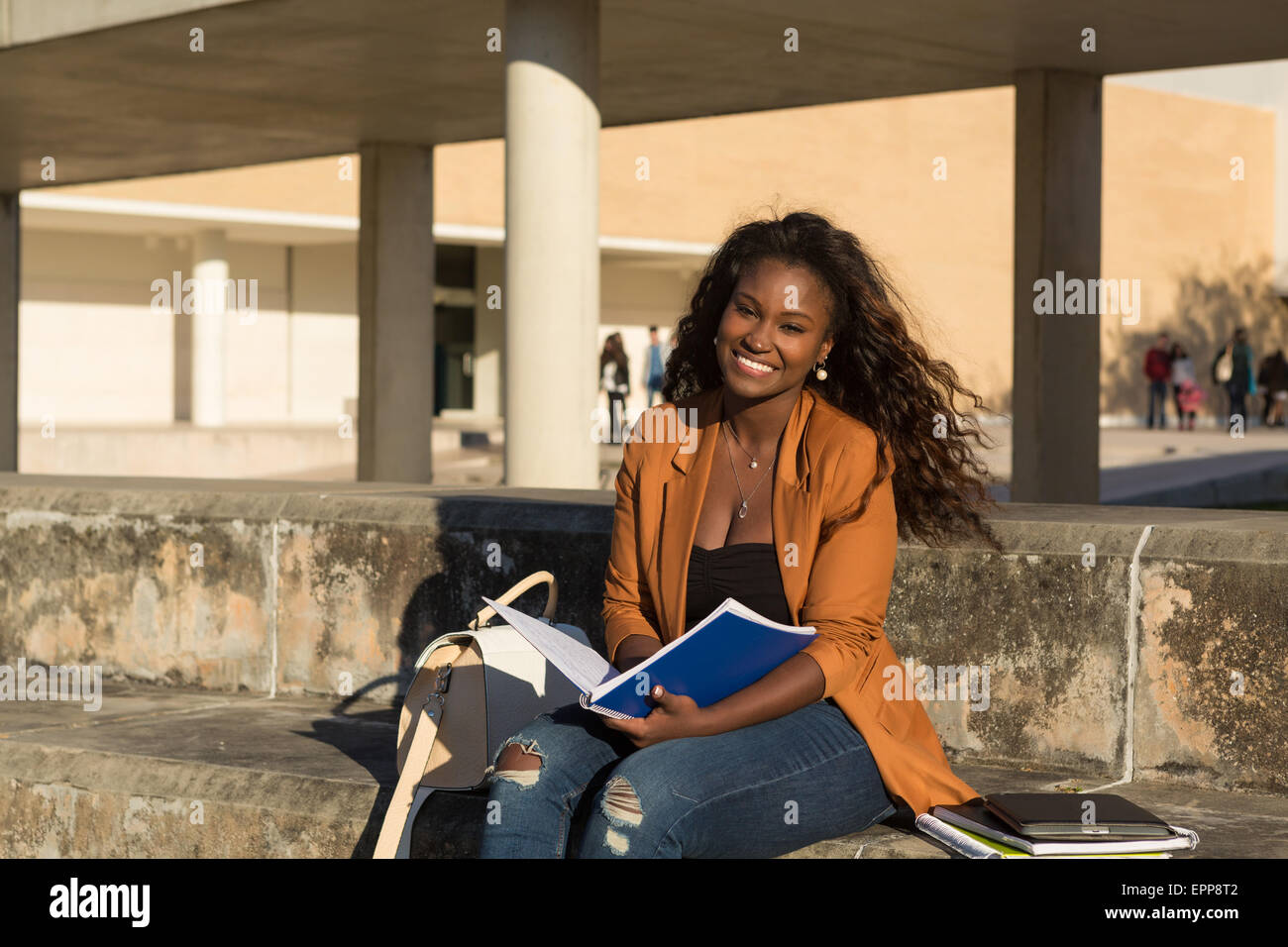 Happy student relaxing at the university campus Stock Photo - Alamy