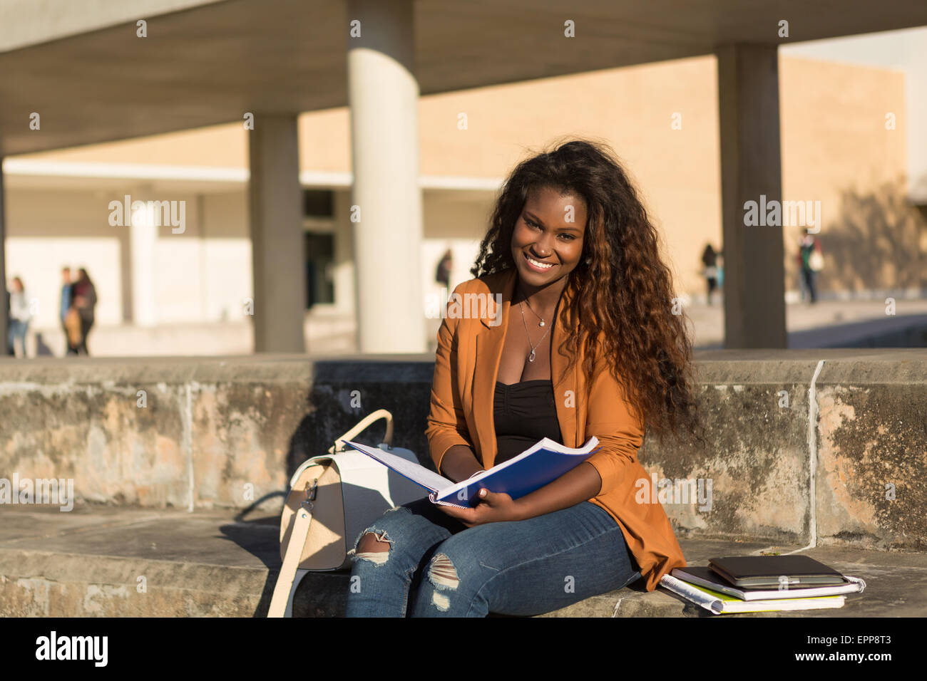 Happy student relaxing at the university campus Stock Photo - Alamy