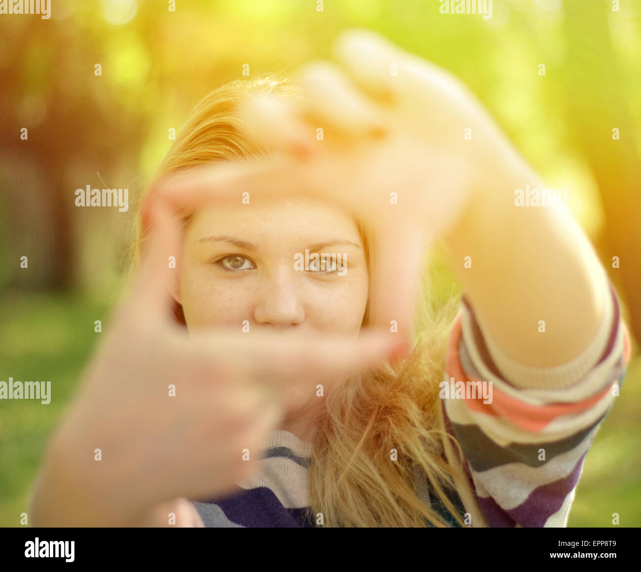 Beautiful girl making frame with hands while outdoors Stock Photo - Alamy