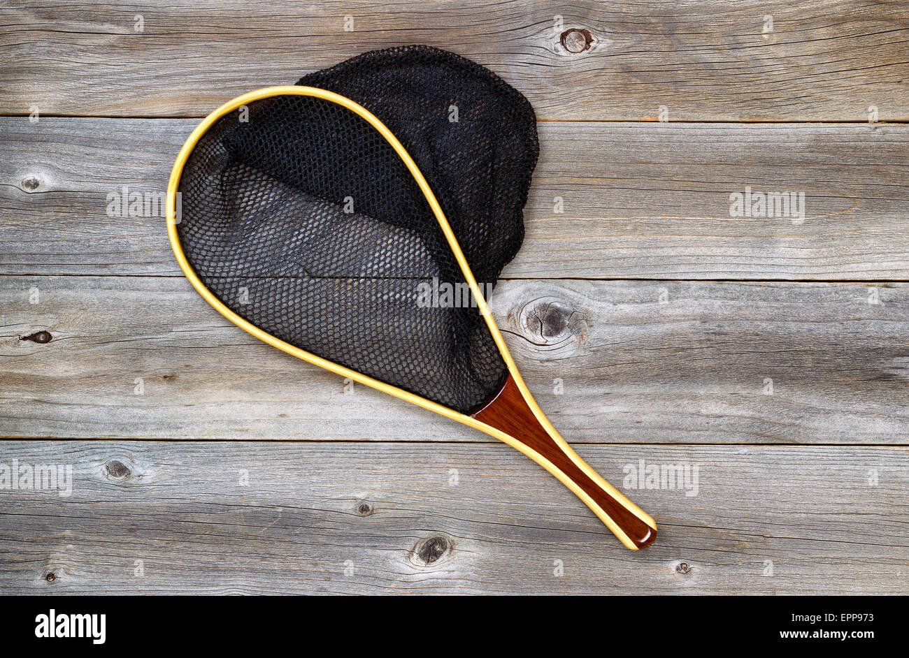 Landing net for trout fishing on rustic wooden boards Stock Photo - Alamy