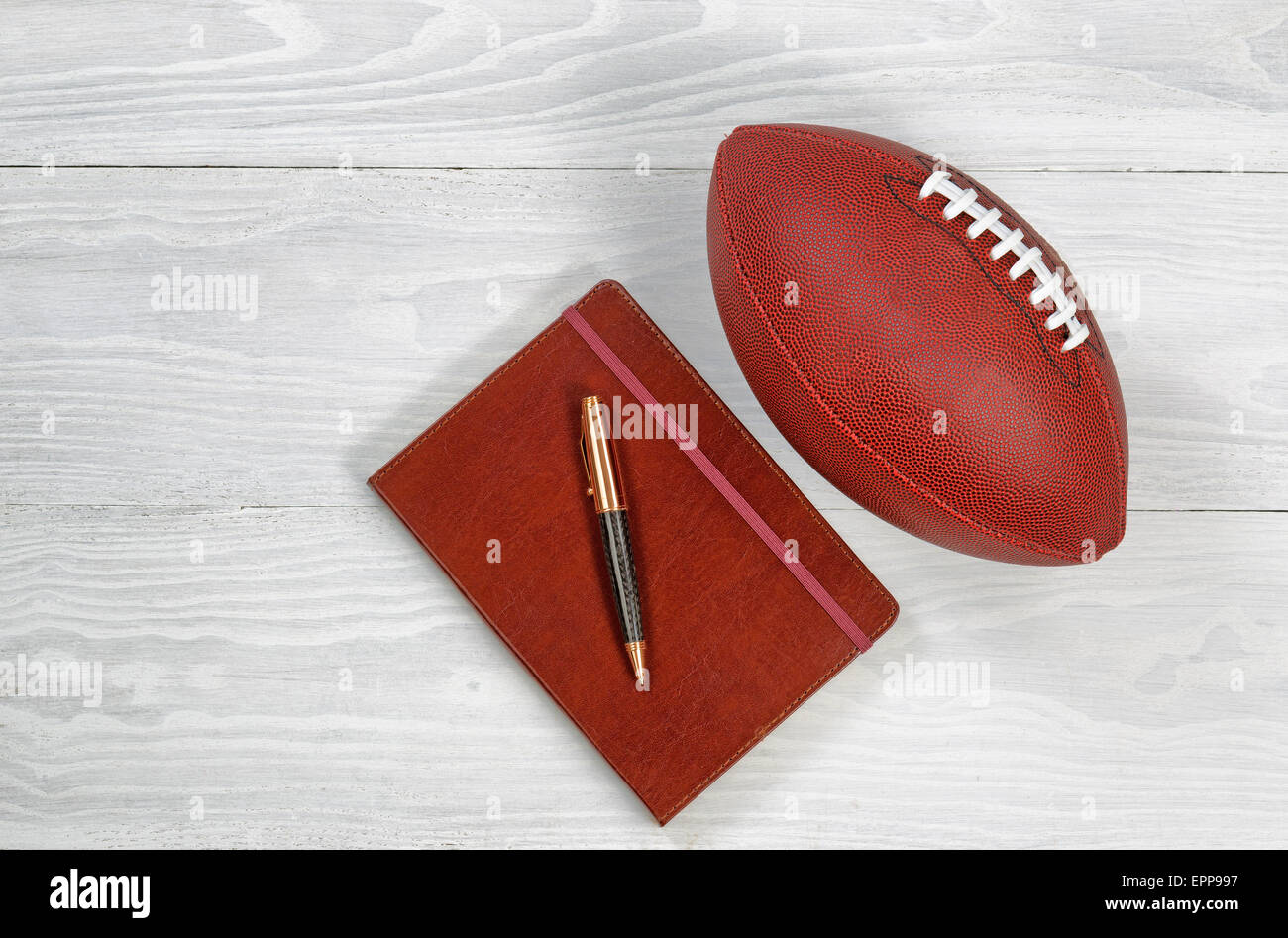 Image of executive notepad, pen and American football on white rustic ...