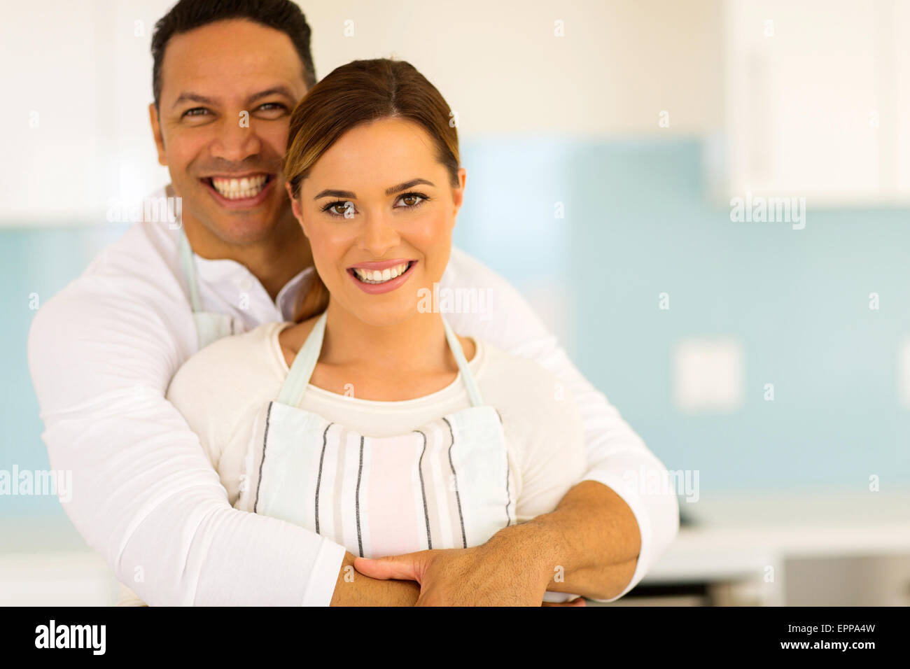 Beautiful couple hugging in kitchen hi-res stock photography and images ...