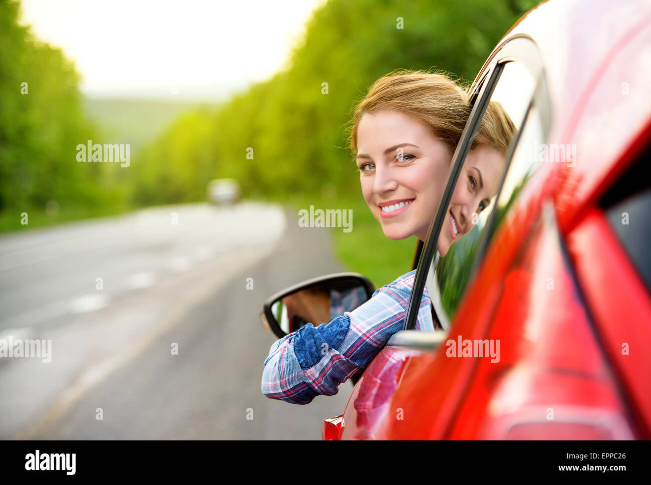 Woman in red car Stock Photo - Alamy