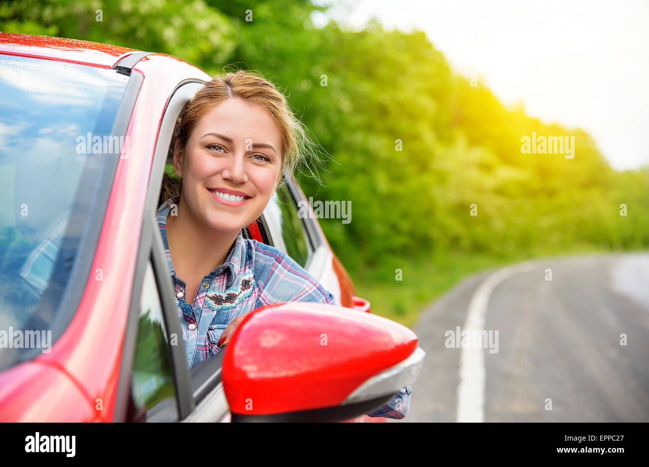 Woman in red car Stock Photo - Alamy