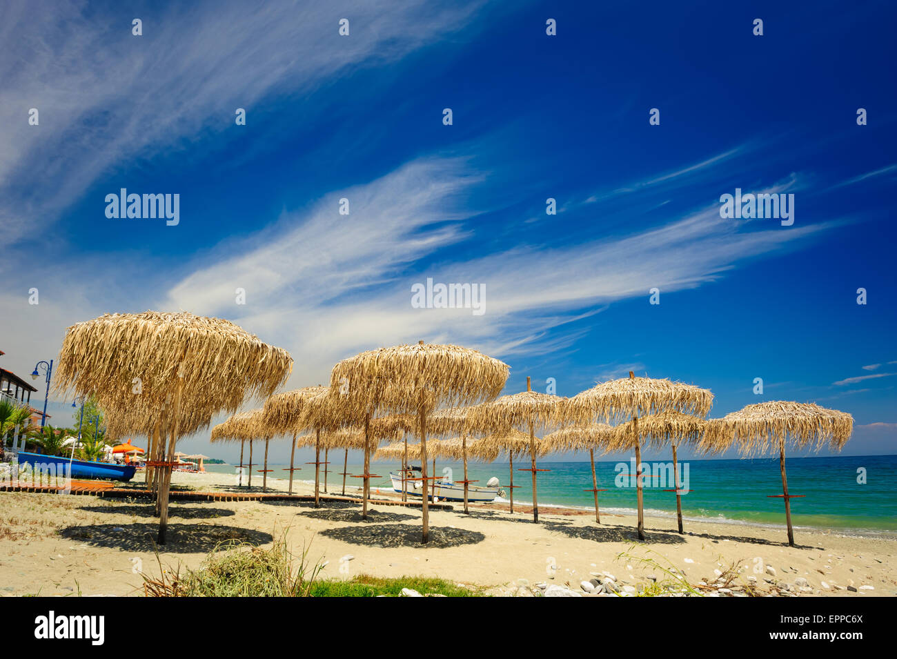 Reed umbrellas on the beach Stock Photo - Alamy