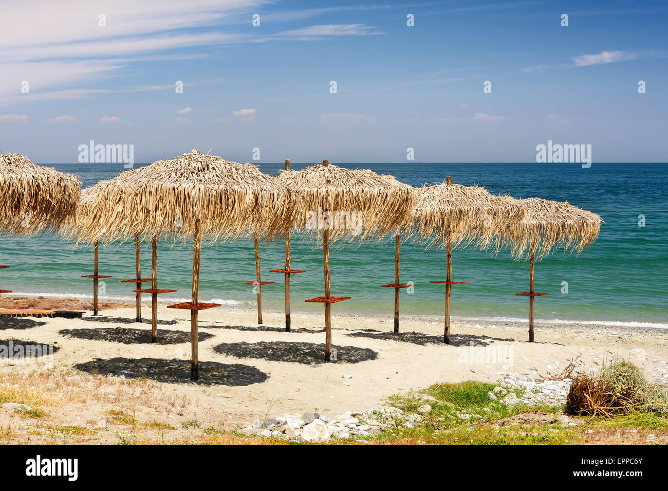Reed umbrellas on the beach Stock Photo - Alamy