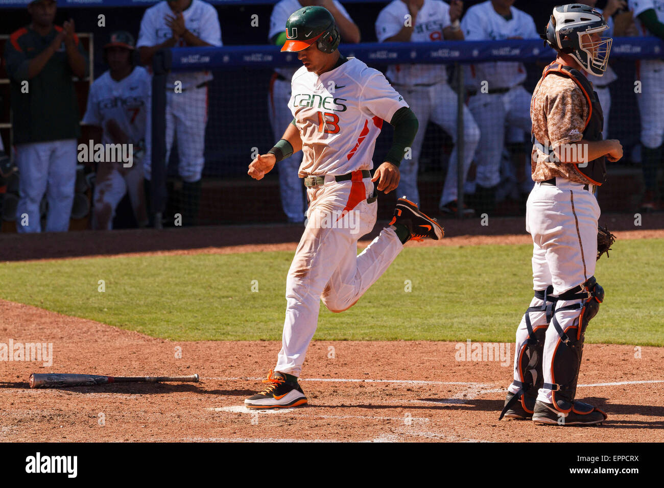 outfielder Willie Abreu (13) of the Miami Hurricanes scores on a sac ...