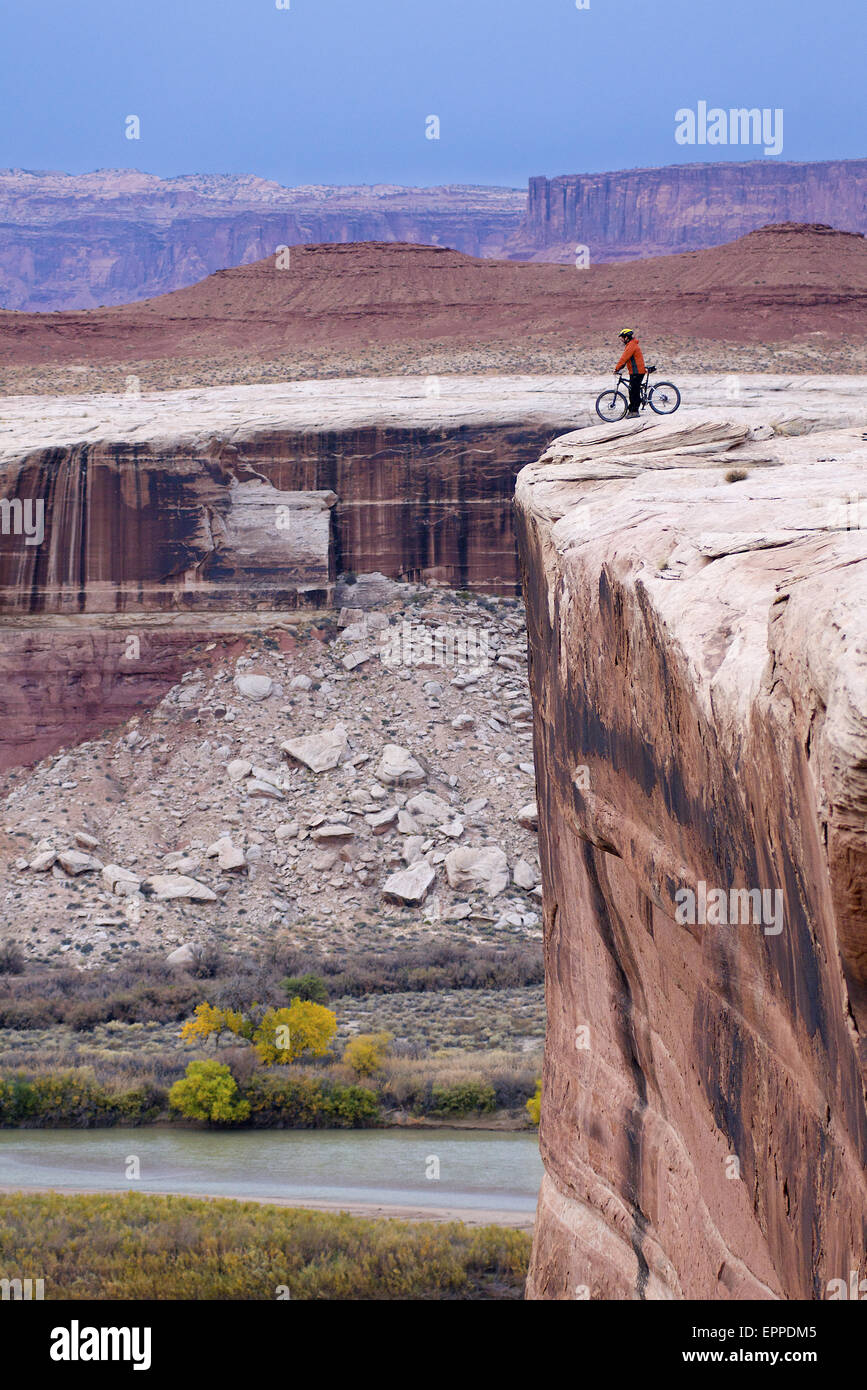 A man with a bicycle at the edge of a cliff Stock Photo - Alamy