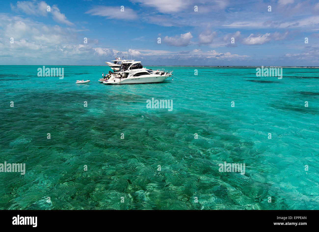 Boats floating in the water off of Half Moon Caye in Belize Stock Photo ...