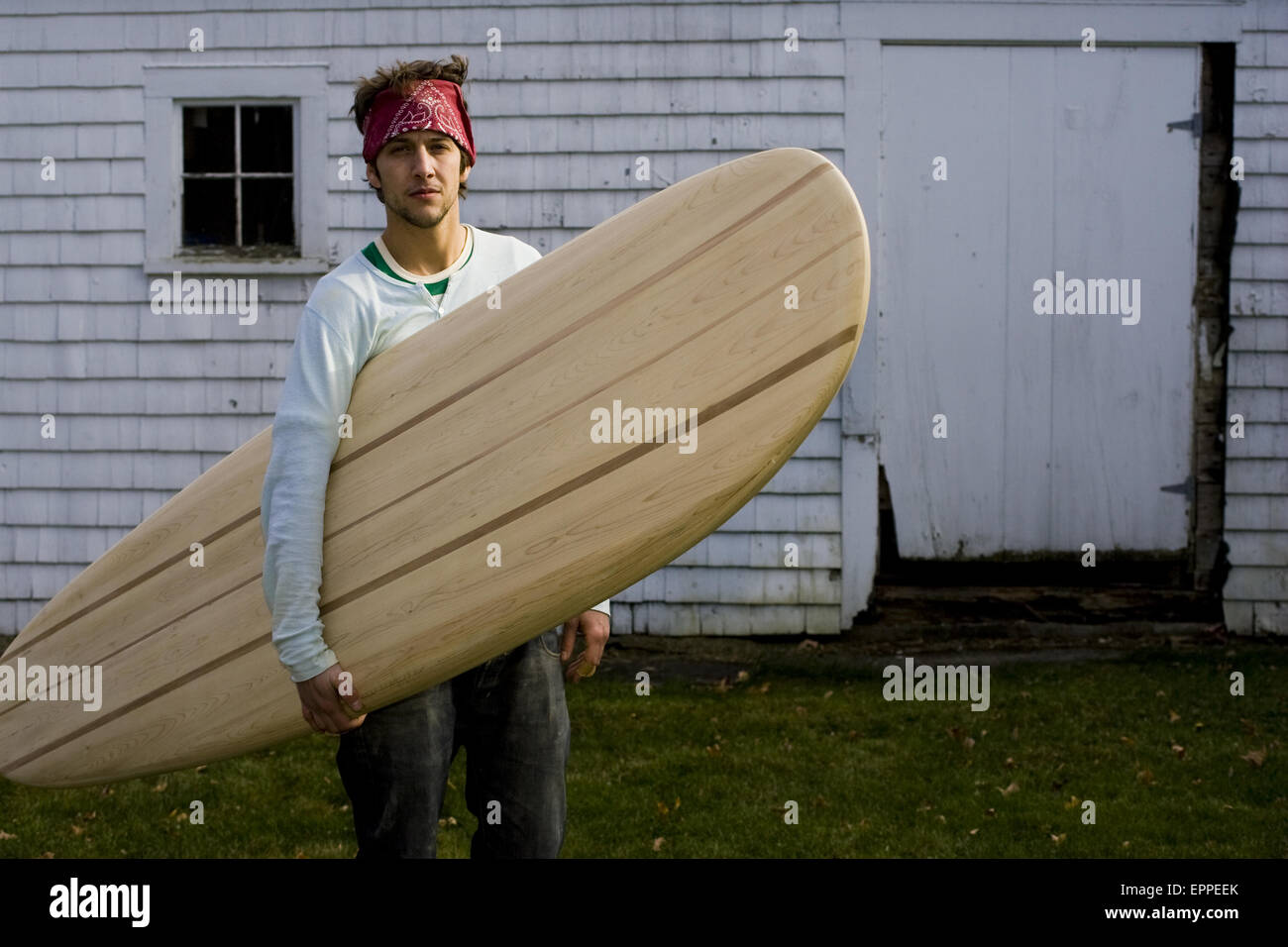 Surfer with wooden surfboard Stock Photo - Alamy