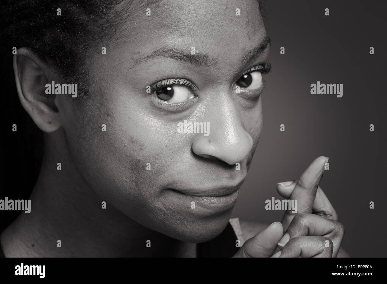 Model fingers crossed wishing lucky Stock Photo - Alamy