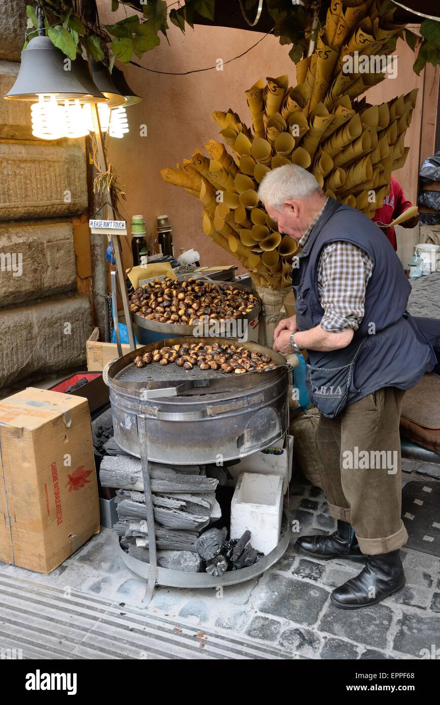 Street vendor roasting chestnuts on a brazier on a street in Rome ...