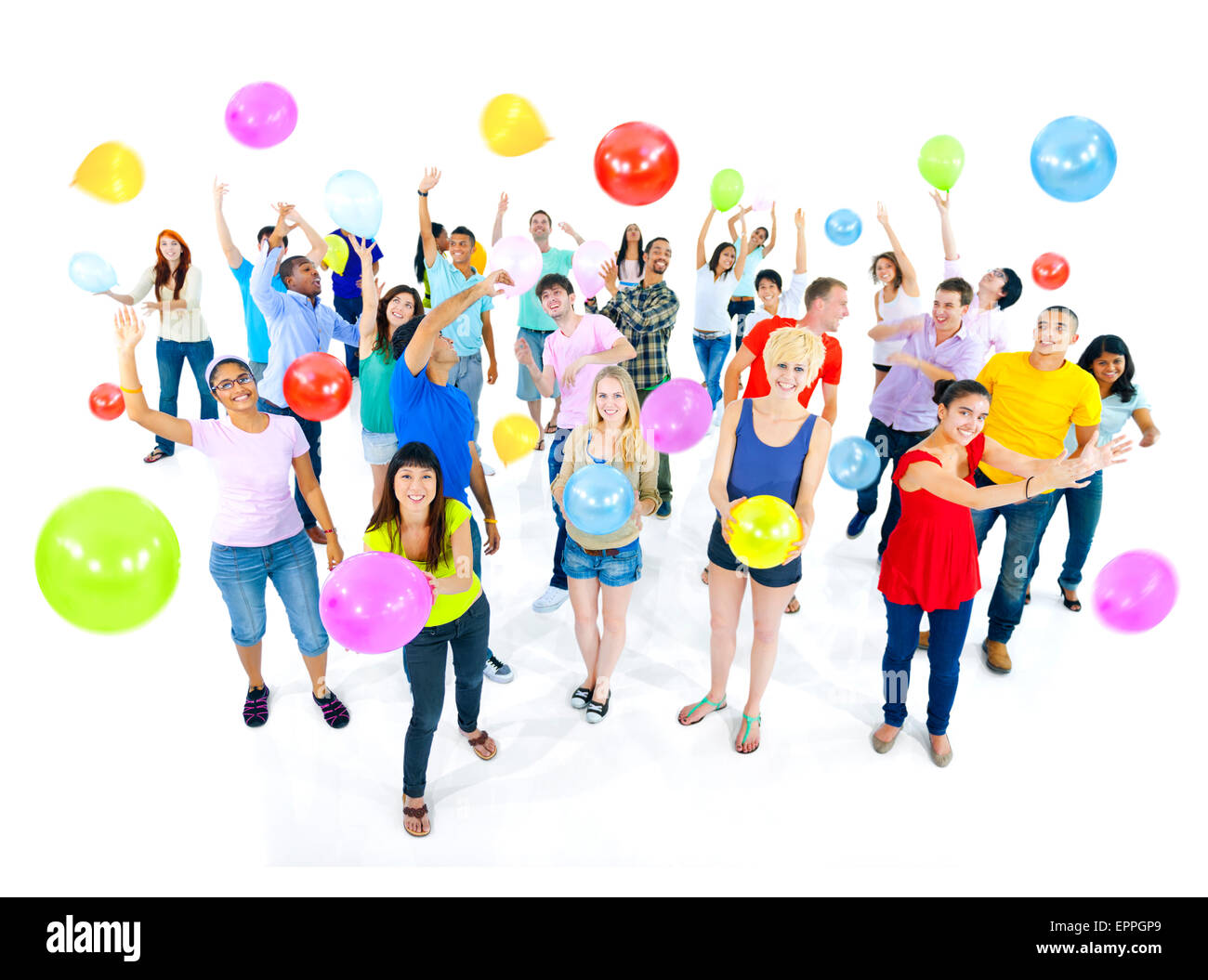Group of diverse multi-ethnic young people celebrating with balloons ...