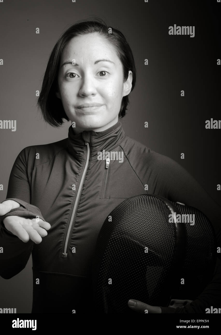Female fencer presenting something Stock Photo - Alamy