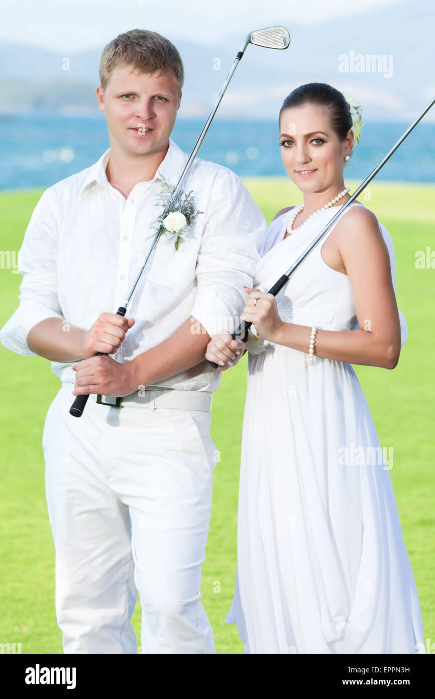 Bride and groom are playing golf at wedding day Stock Photo - Alamy