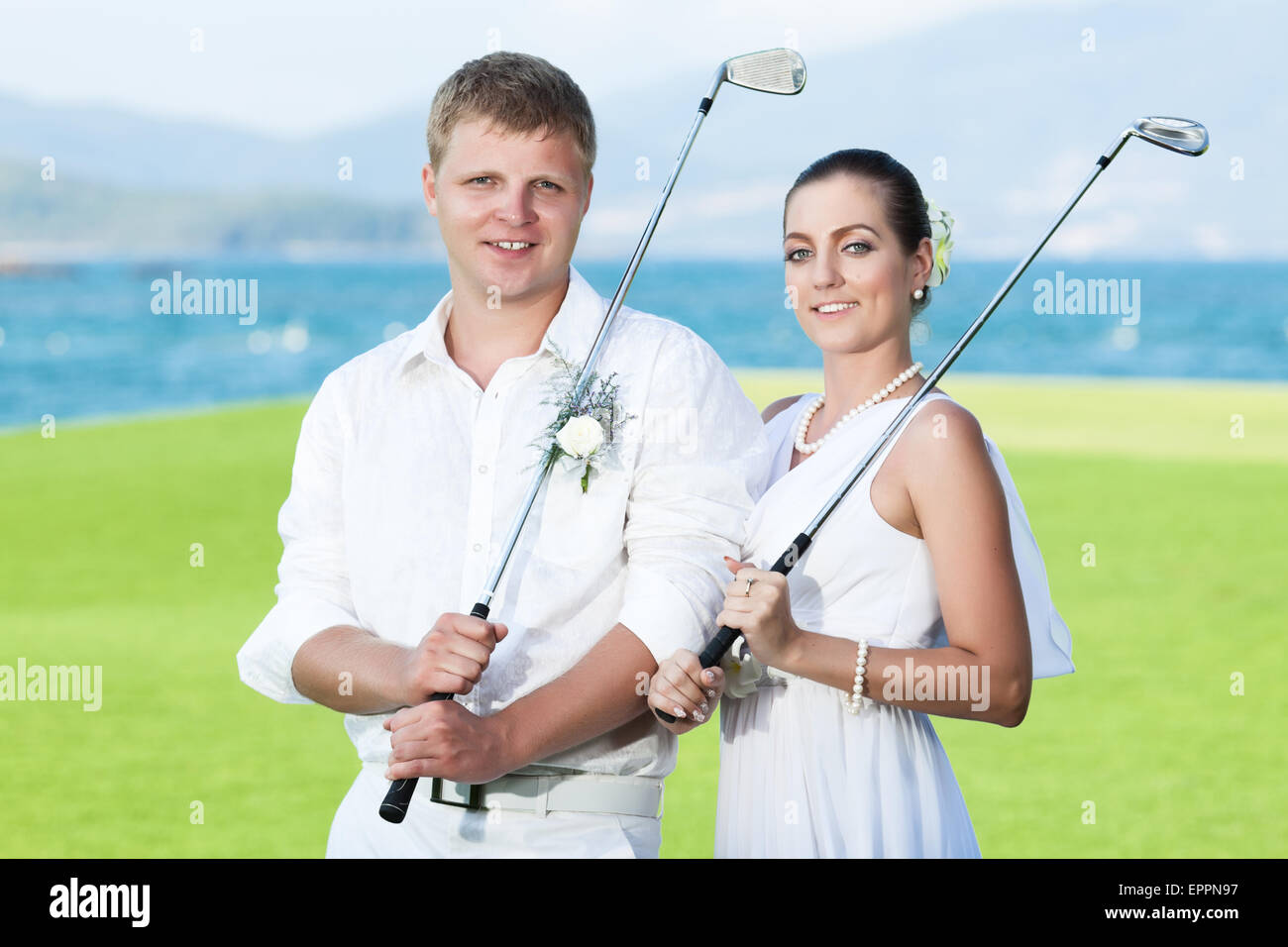 Bride and groom are playing golf at wedding day Stock Photo - Alamy