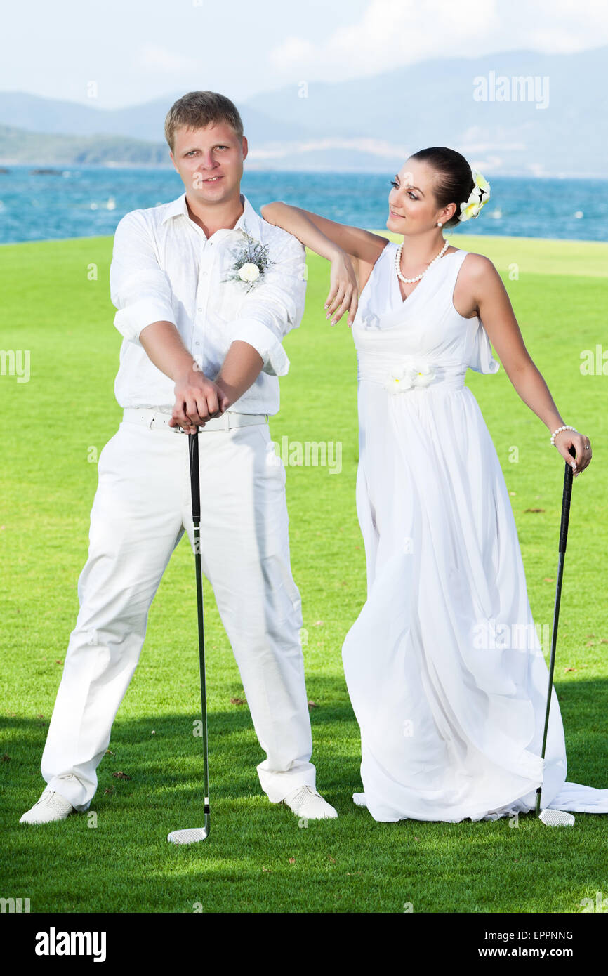 Bride and groom are playing golf at wedding day Stock Photo - Alamy