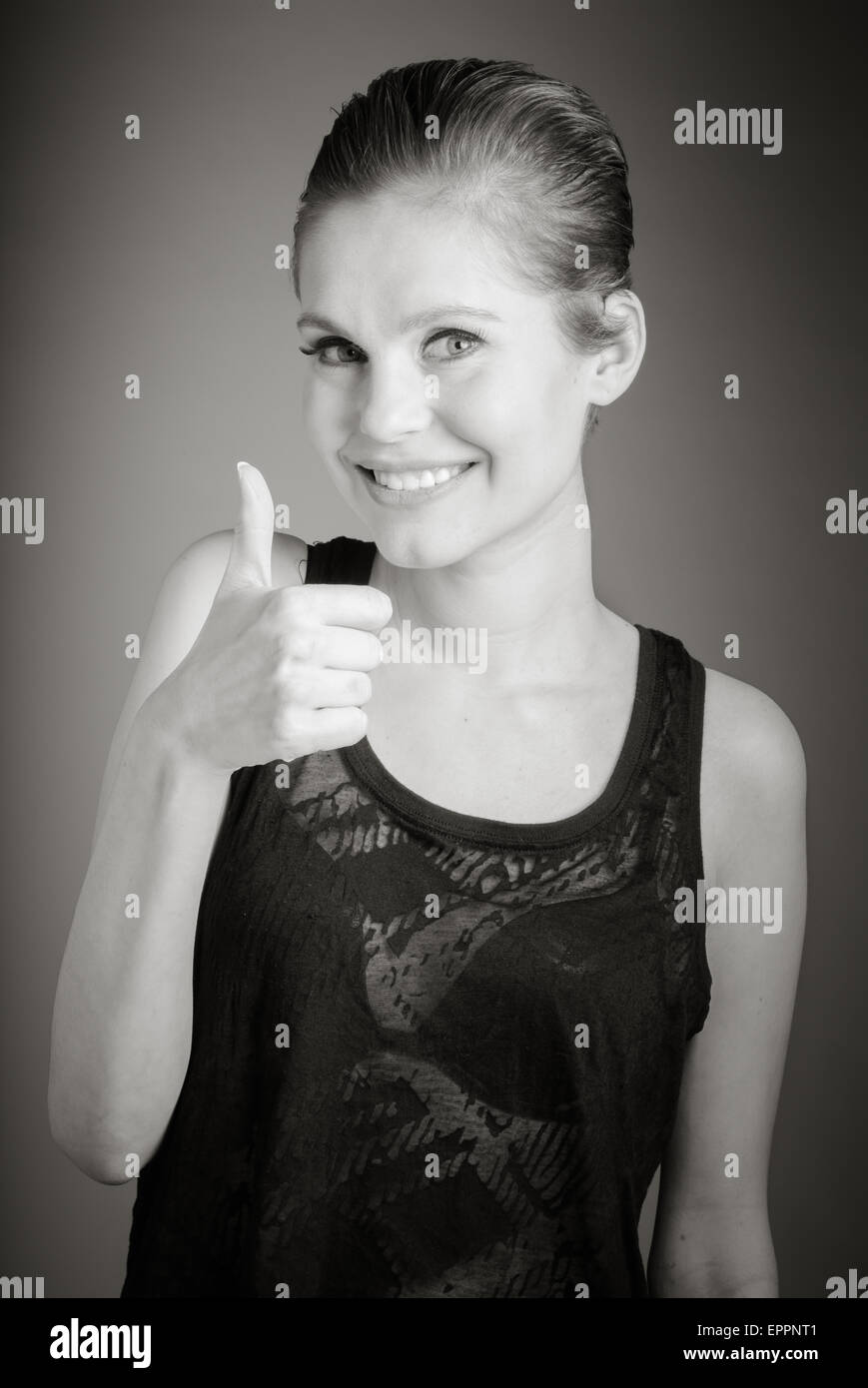 Young woman carrying exercise mat showing ok sign Stock Photo - Alamy