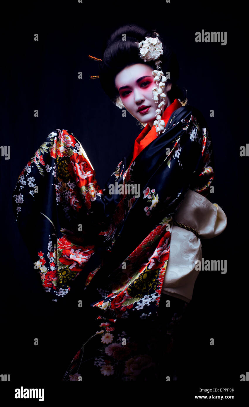 young pretty real geisha in kimono with sakura and decoration Stock ...