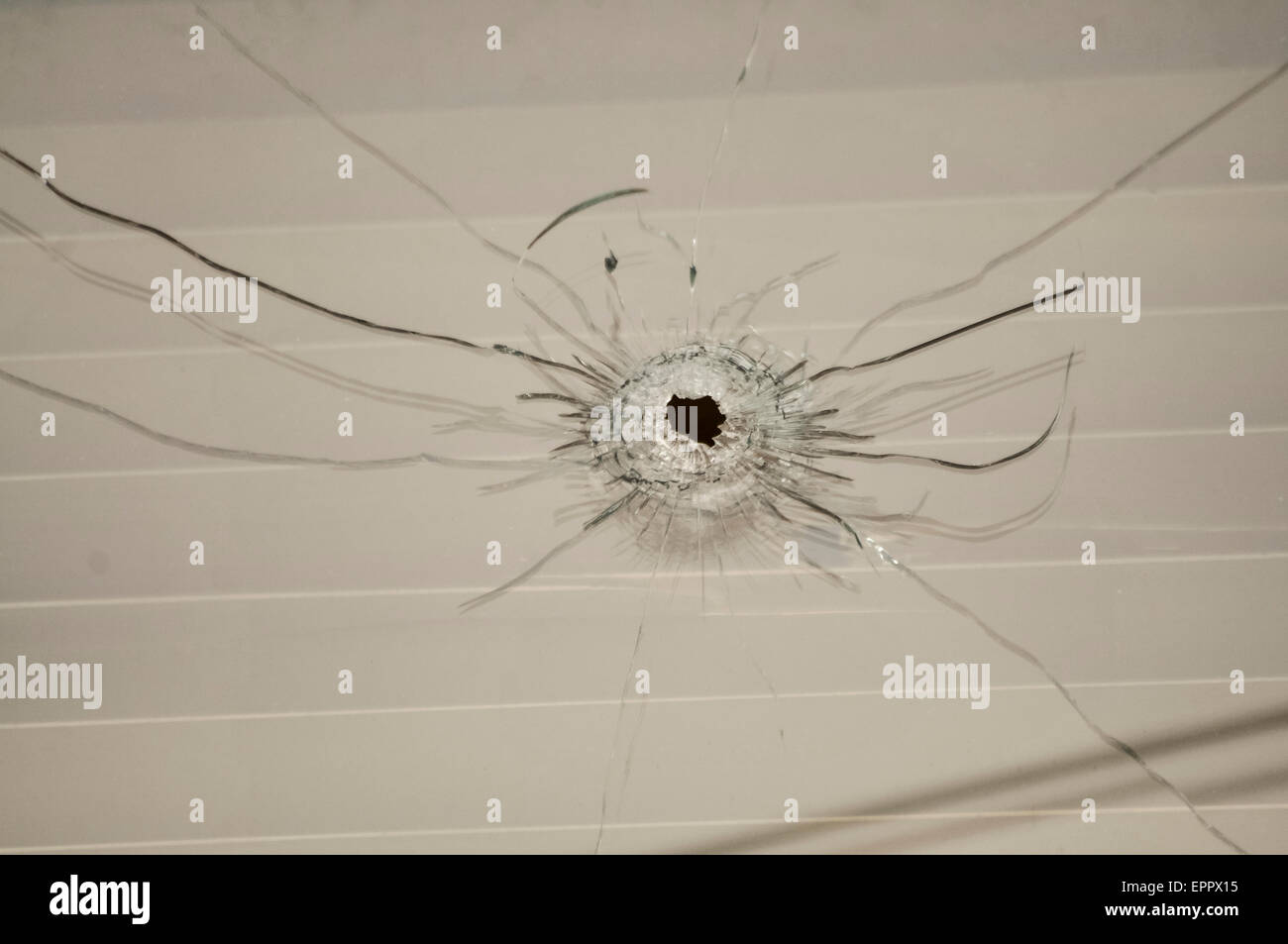 Bullet hole left in a window after a gun attack on a house Stock Photo ...