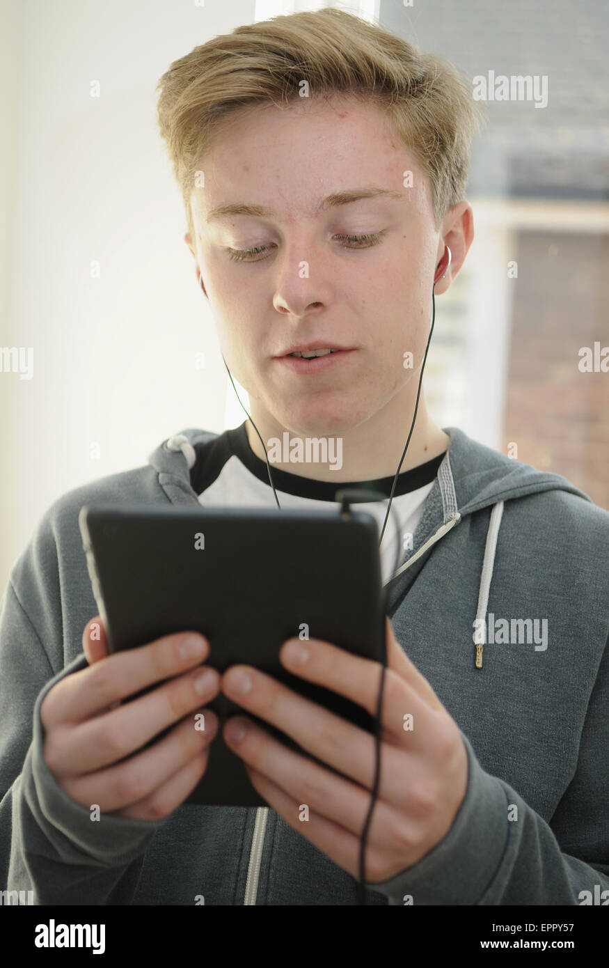 Teenage boy using an Apple iPad Tablet Stock Photo - Alamy