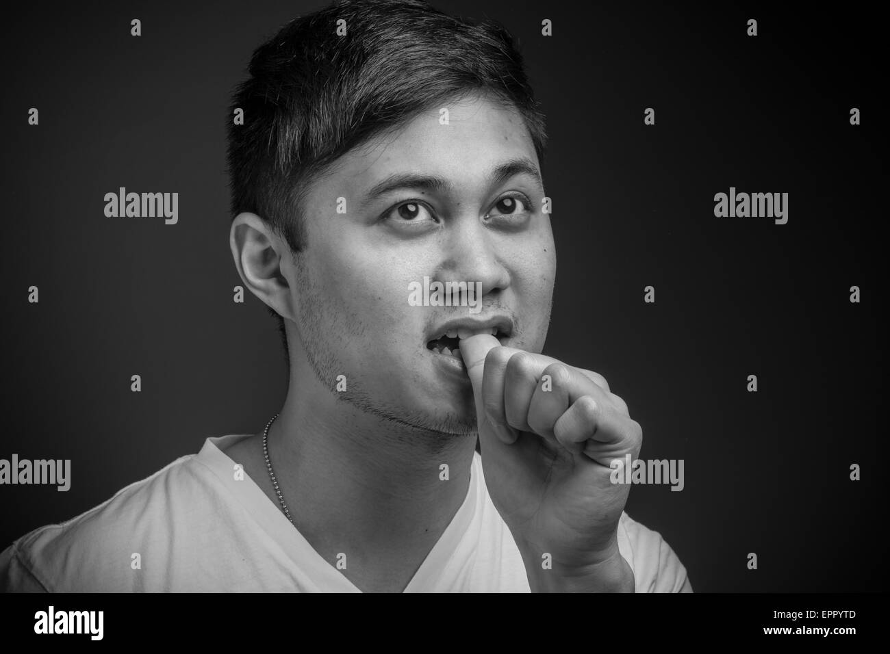 Biting your finger Black and White Stock Photos & Images - Alamy