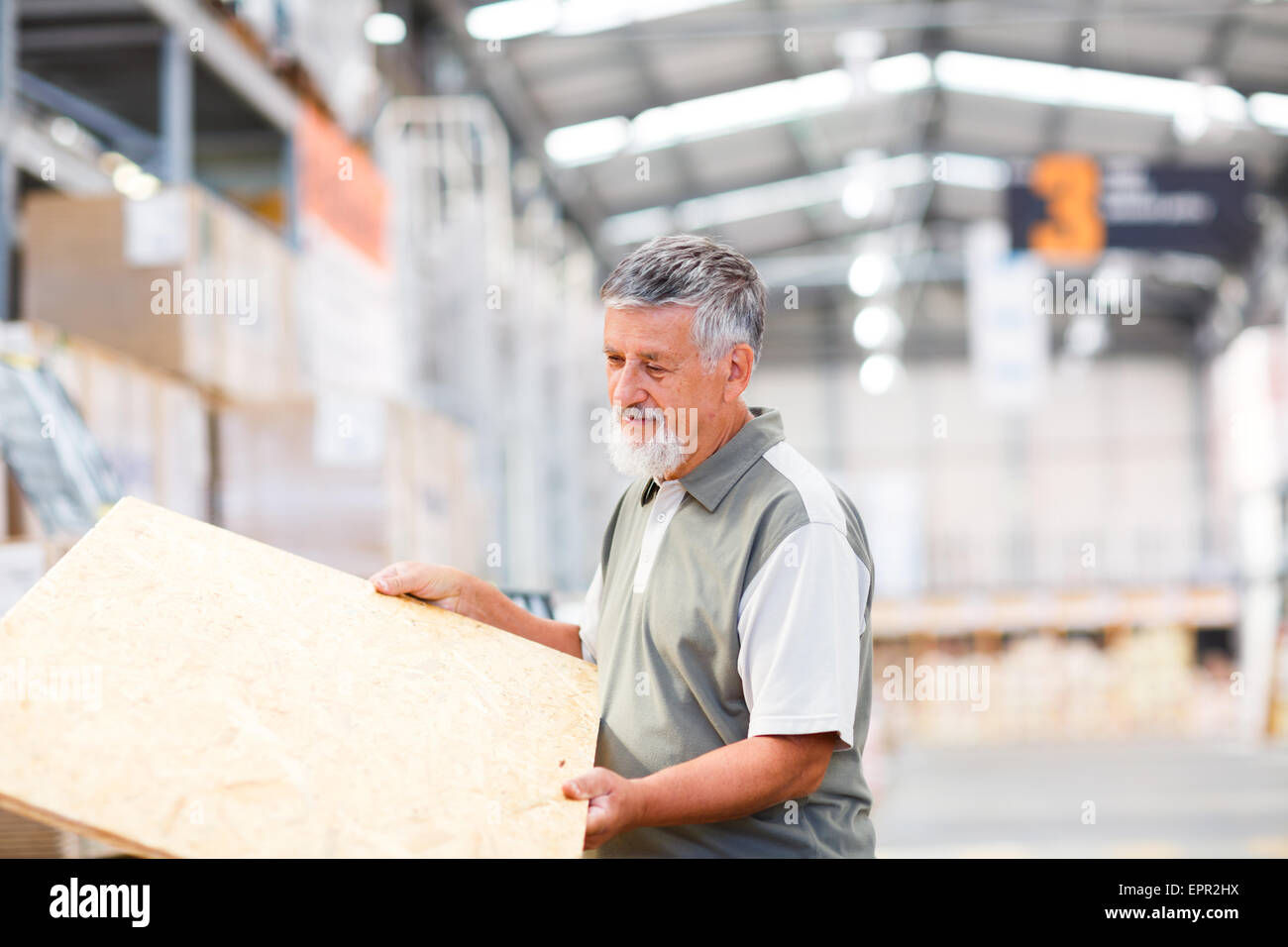 Man buying construction wood in a DIY store for his DIY home re ...