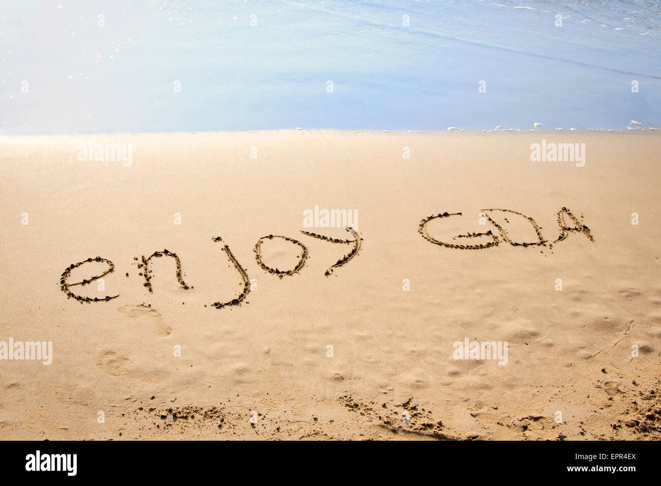 The Words Enjoy Goa Written in the Sand on a Beach Stock Photo - Alamy