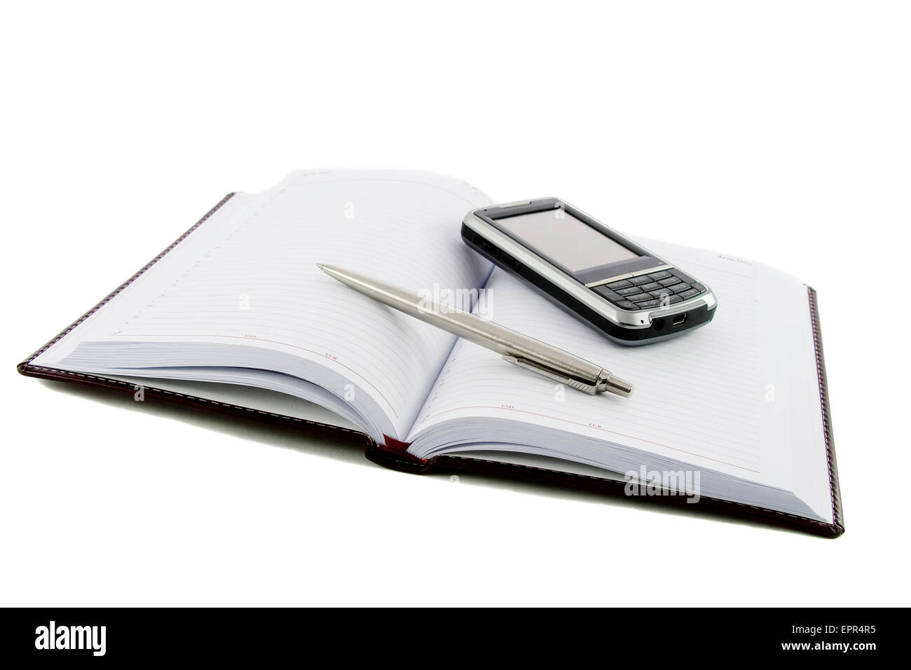 Close up notebook, pen and mobile phone on it isolated over whit Stock ...
