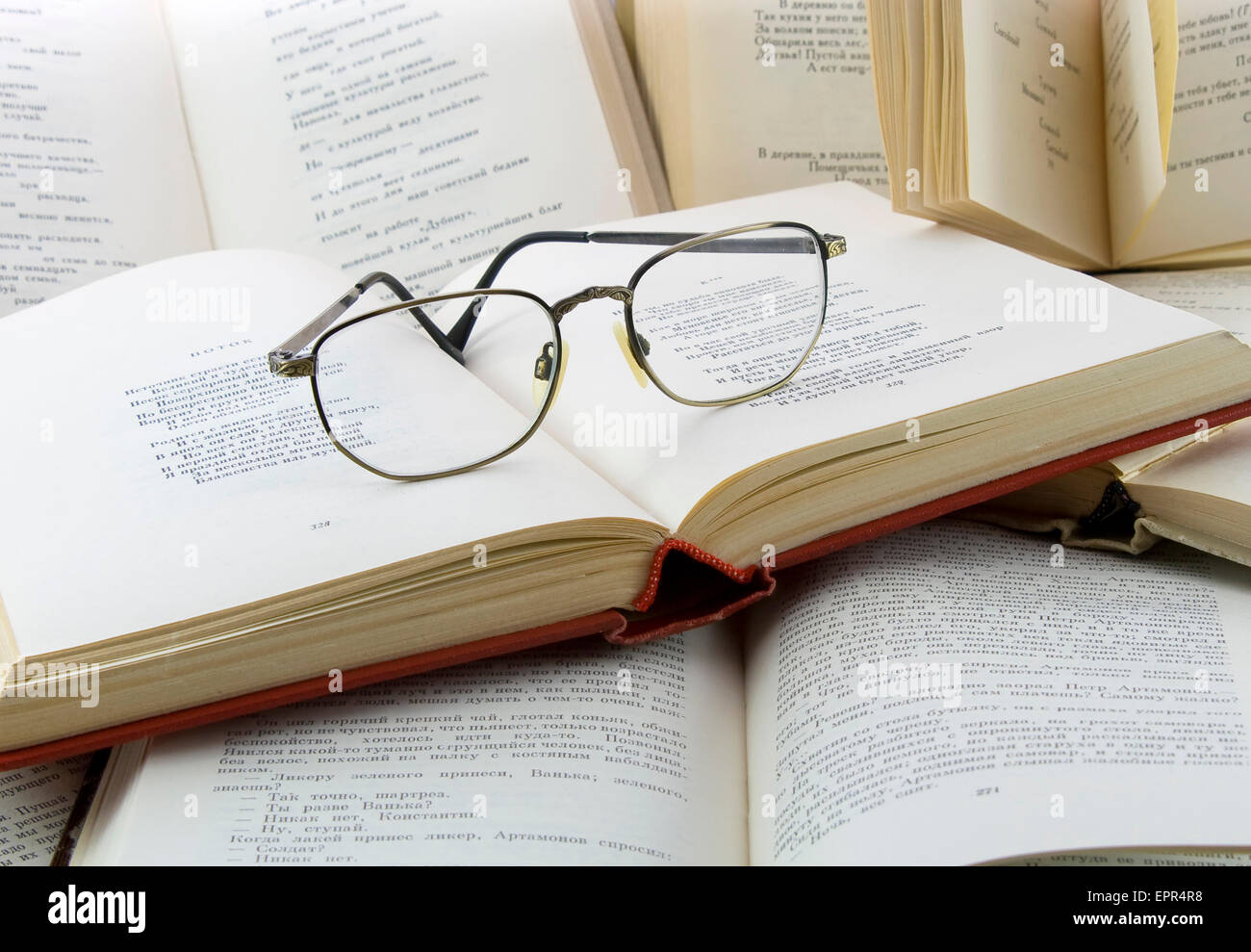 Many open books and glasses on it Stock Photo - Alamy